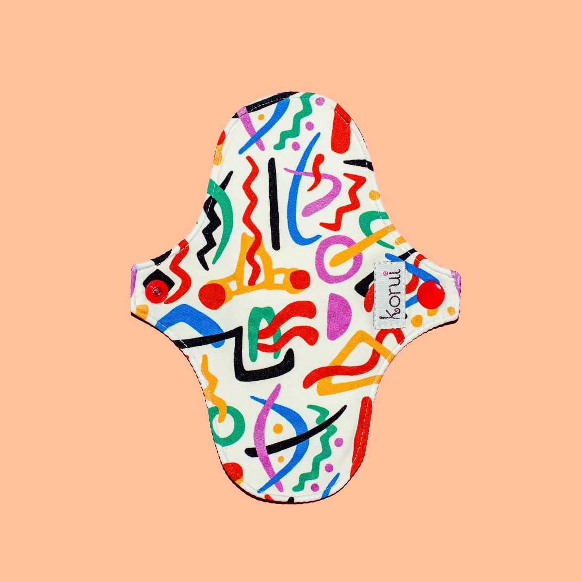 Contém:. 1 Absorvente Mini com abas. *As cores dos botões variam ...